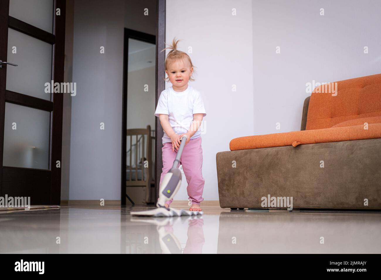 little daughter cleaning in the house, child dusting, Cute little ...