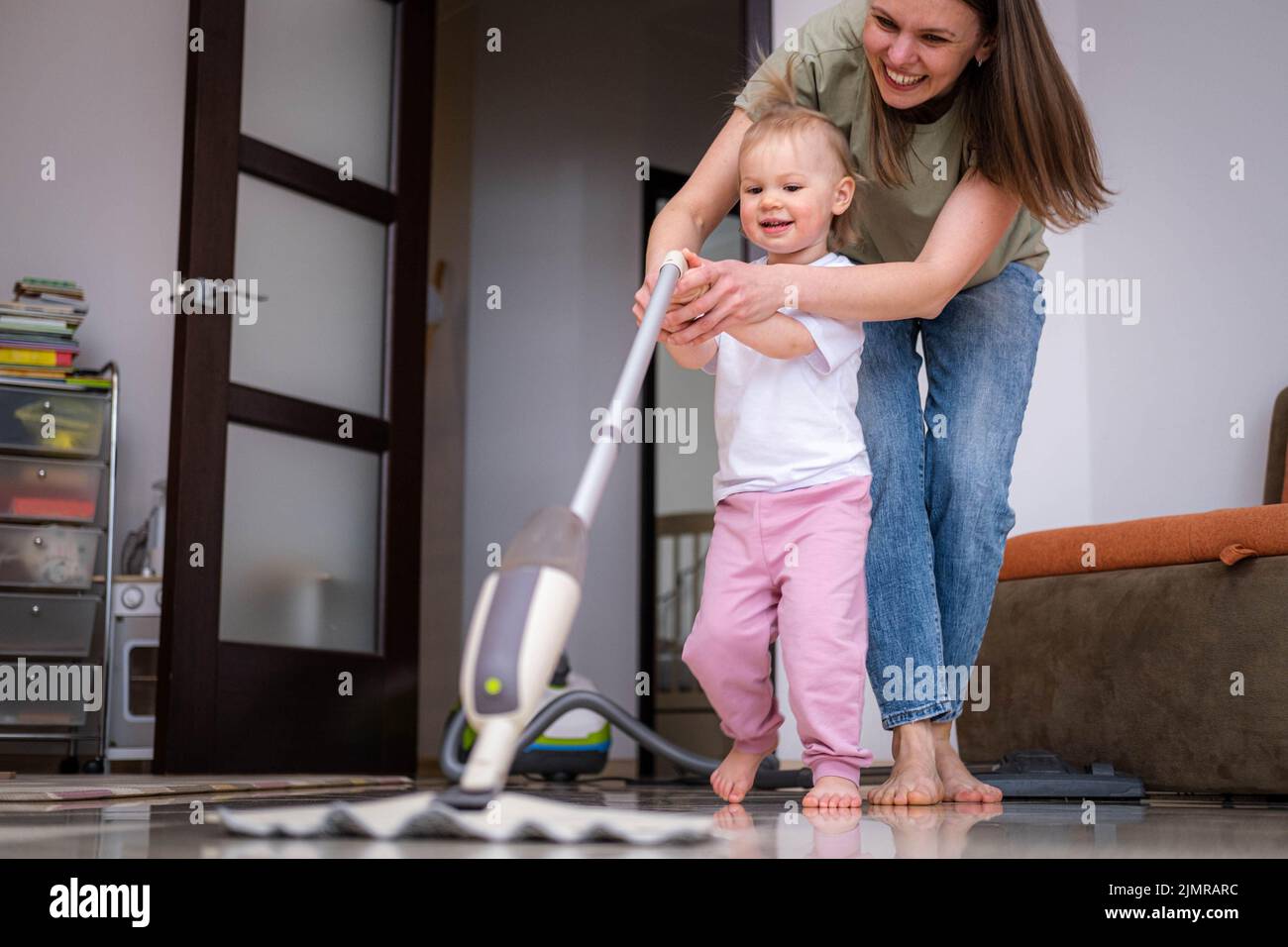 little daughter cleaning in the house, child dusting, Cute little ...