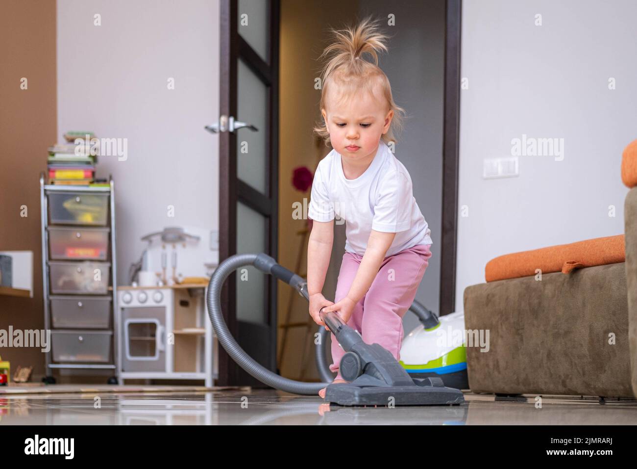 little daughter cleaning in the house, child dusting, Cute little ...