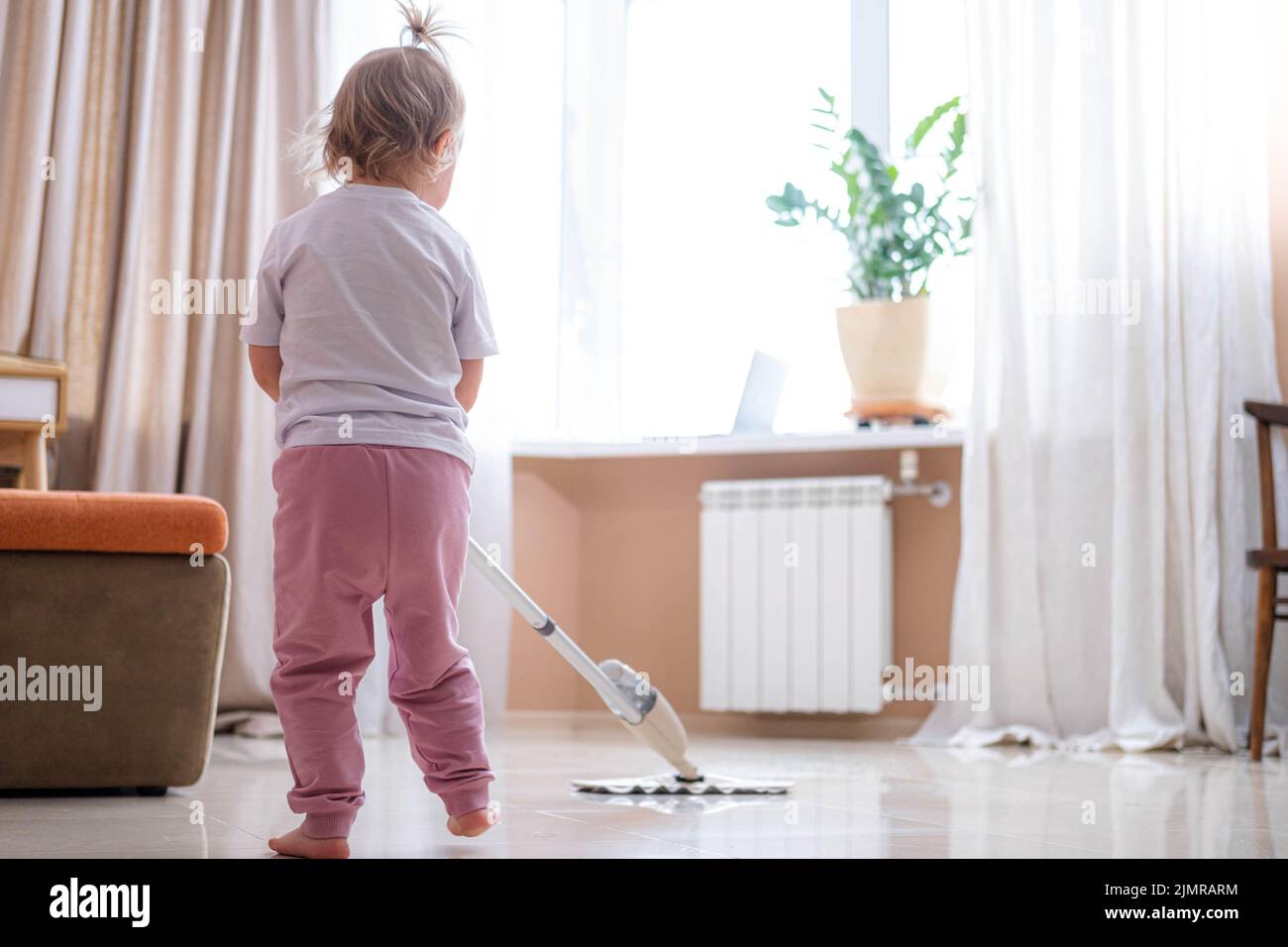 little daughter cleaning in the house, child dusting, Cute little ...