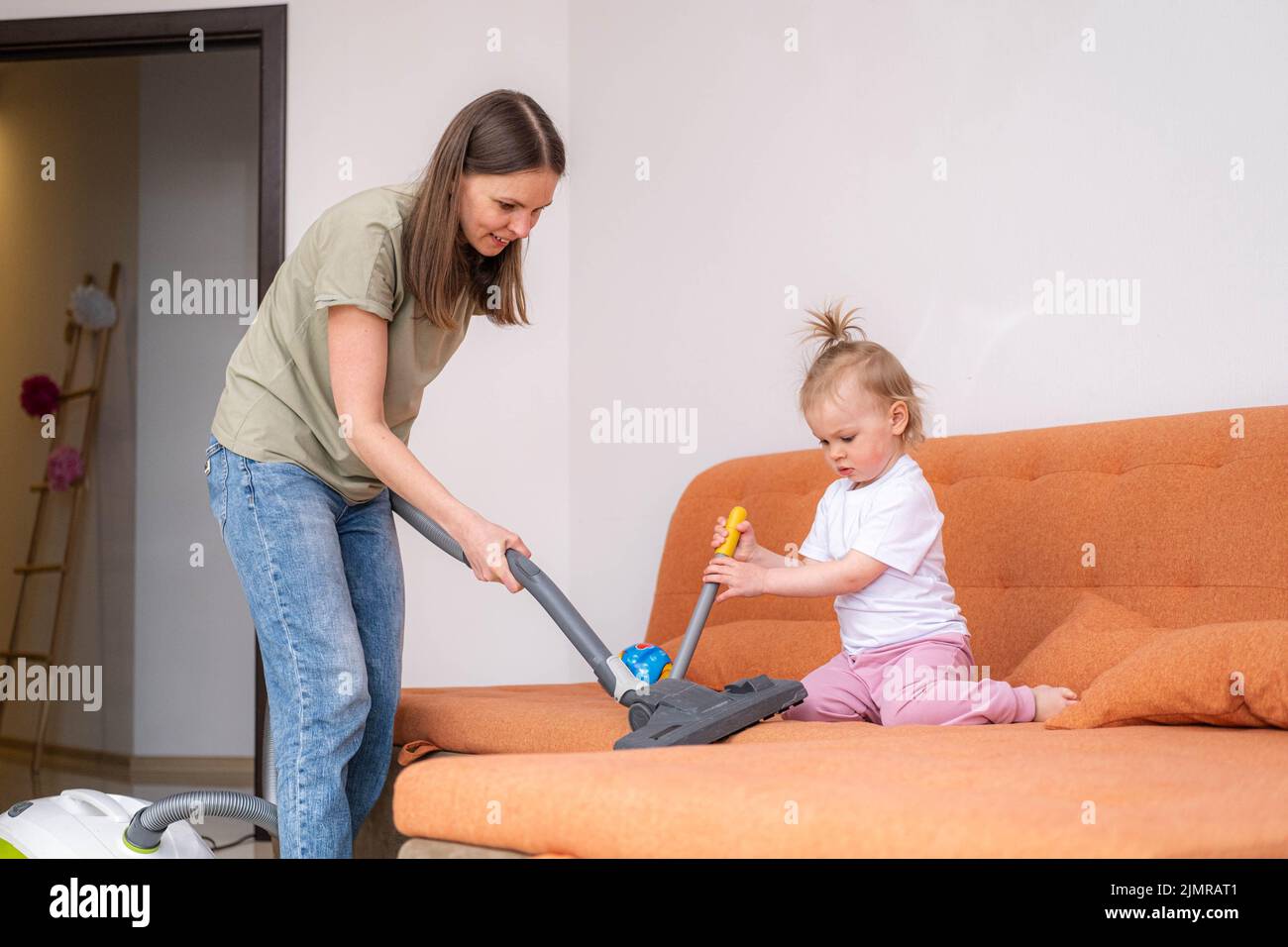 little daughter cleaning in the house, child dusting, Cute little ...
