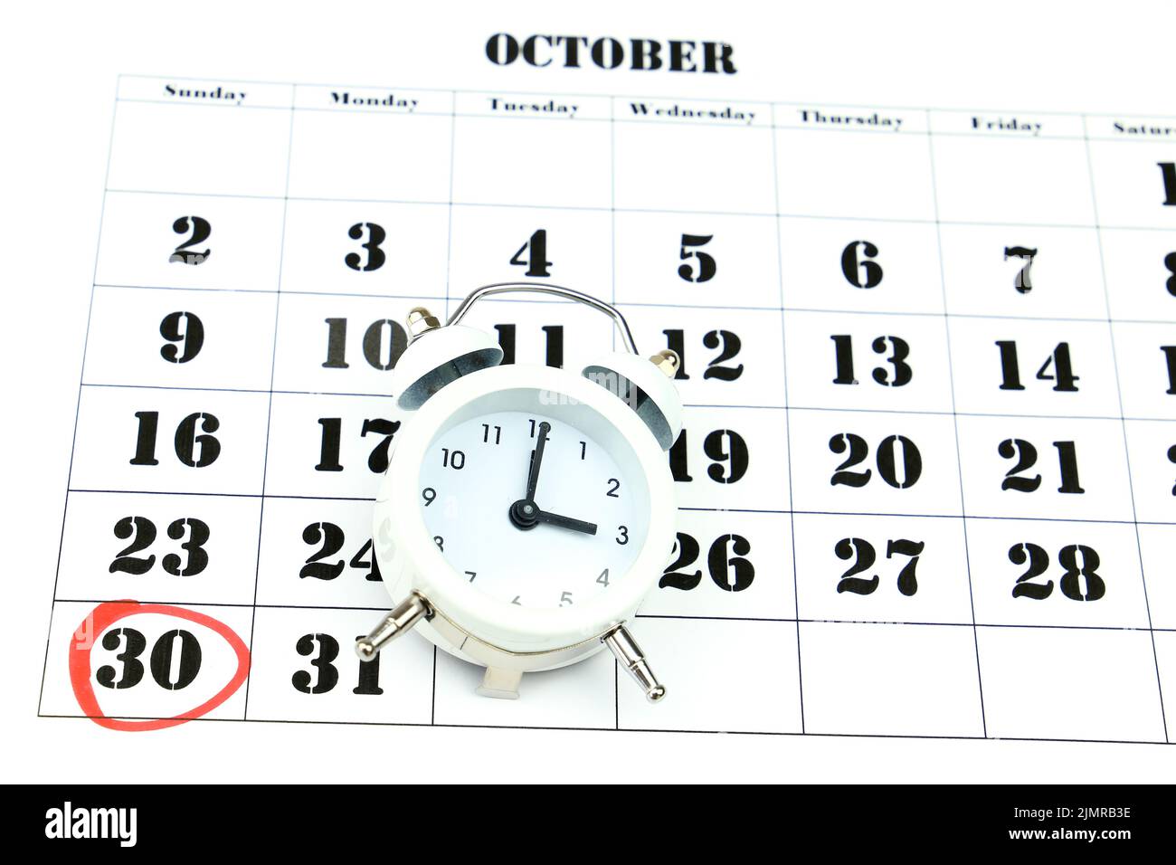 Clock marking winter time change over october calendar Stock Photo - Alamy