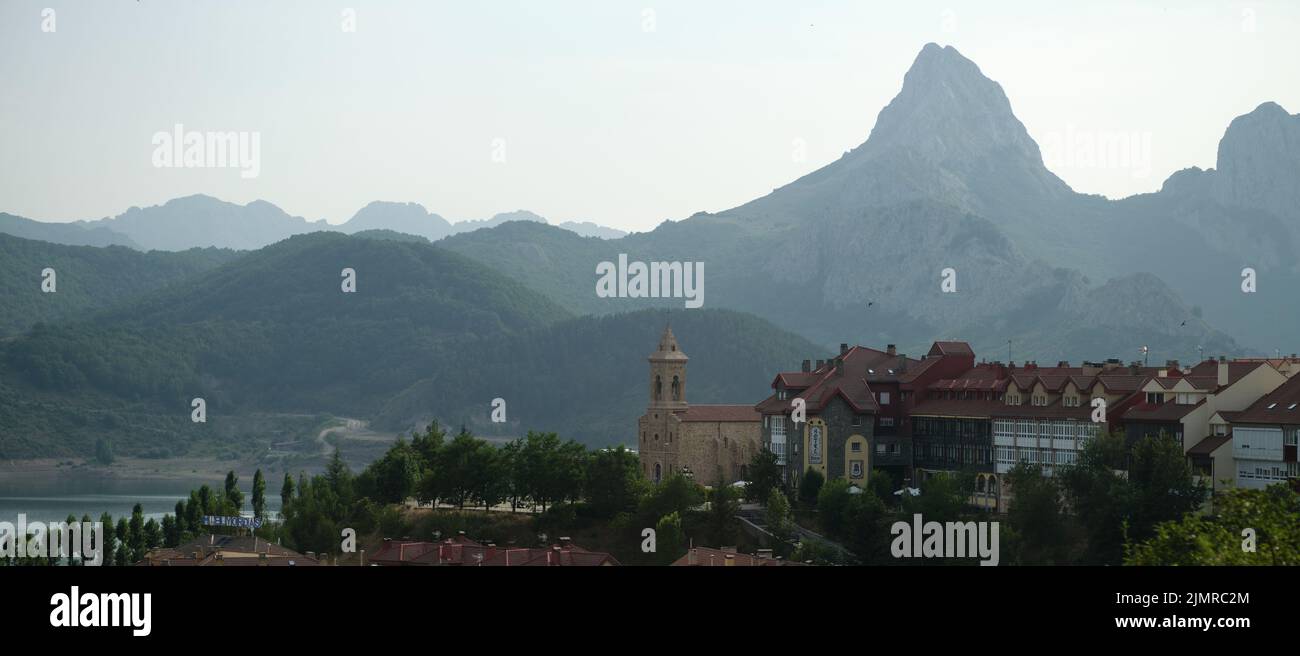 View of misty Riaño village in León, Spain. The parish church of Santa ...