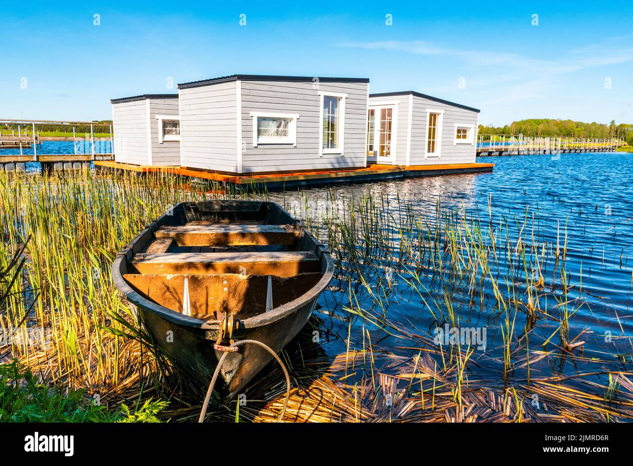 Floating fishing cabins on the blue water of a park lake Stock Photo ...