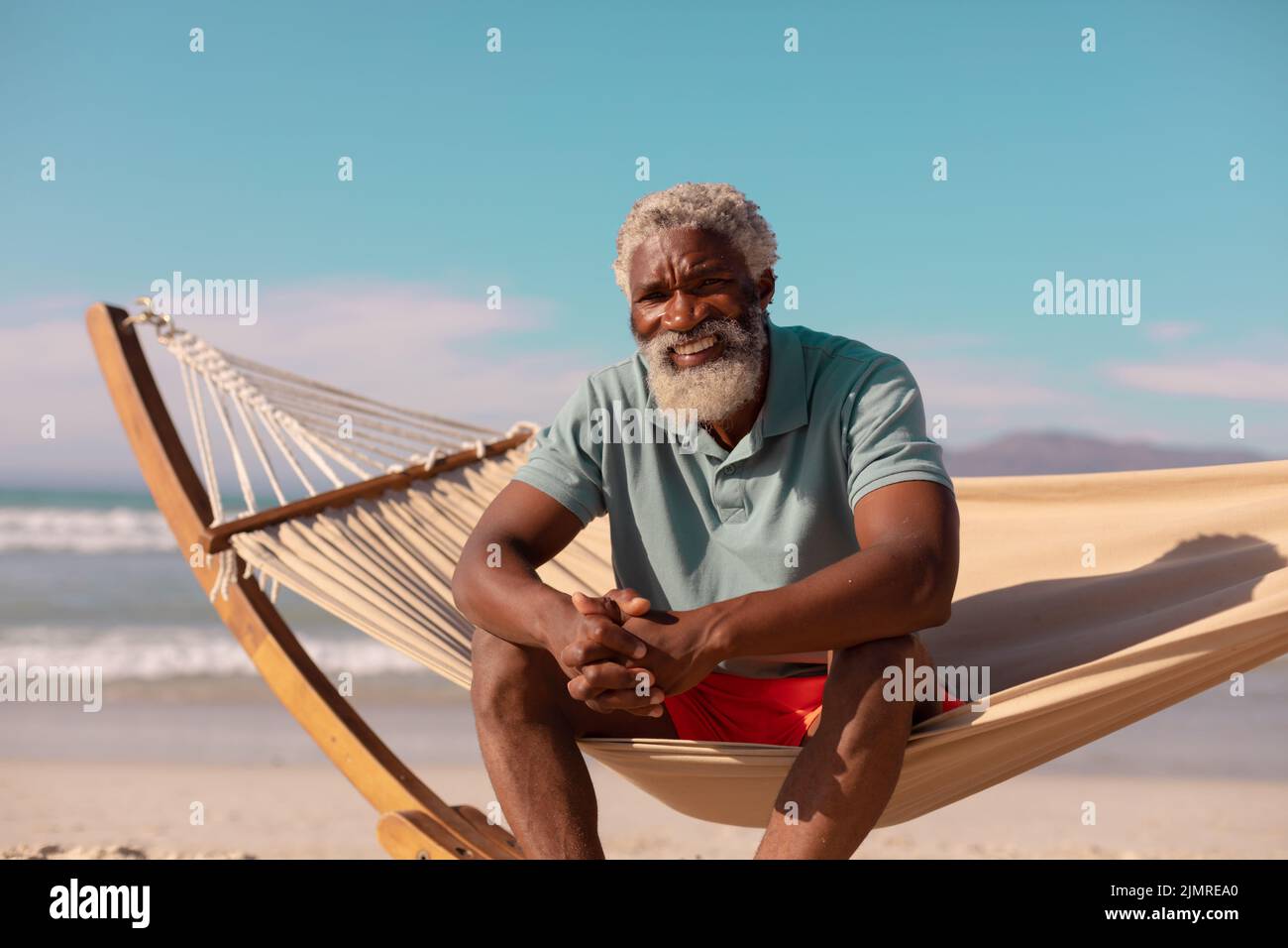 Portrait of happy african american bearded senior man sitting on ... Portrait of happy african american bearded senior man sitting on ...
