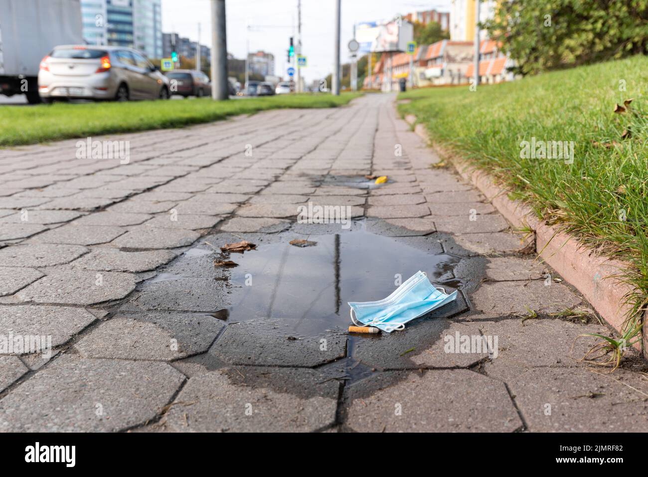 Ppe mask lies in a puddle hi-res stock photography and images - Alamy