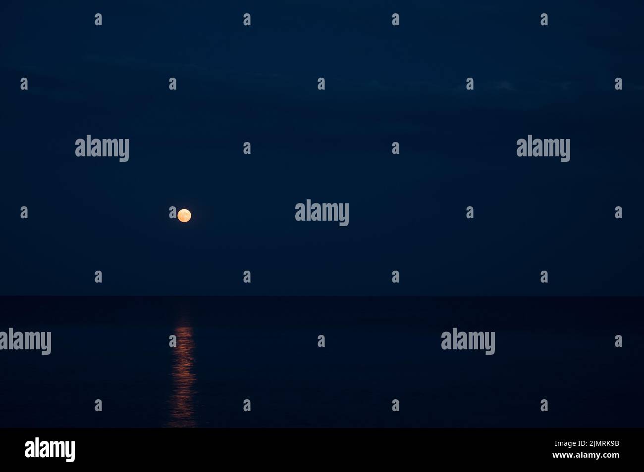 Night landscape. Full moon over the sea. Reflection of the moon path ...