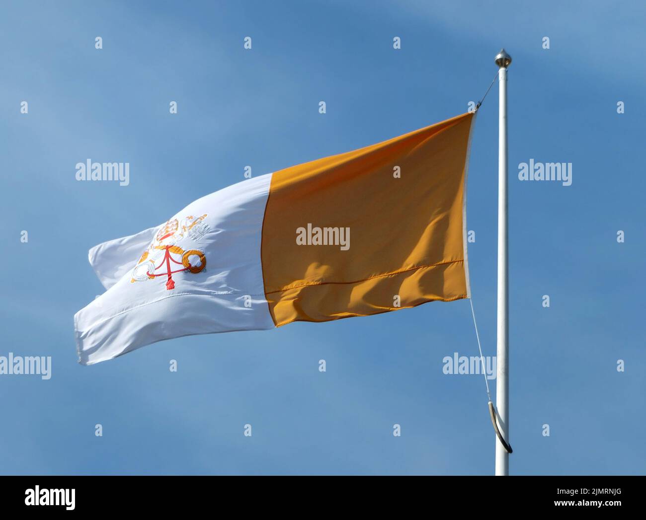 Vatican state flag flying against a bright blue sunlit sky Stock Photo ...