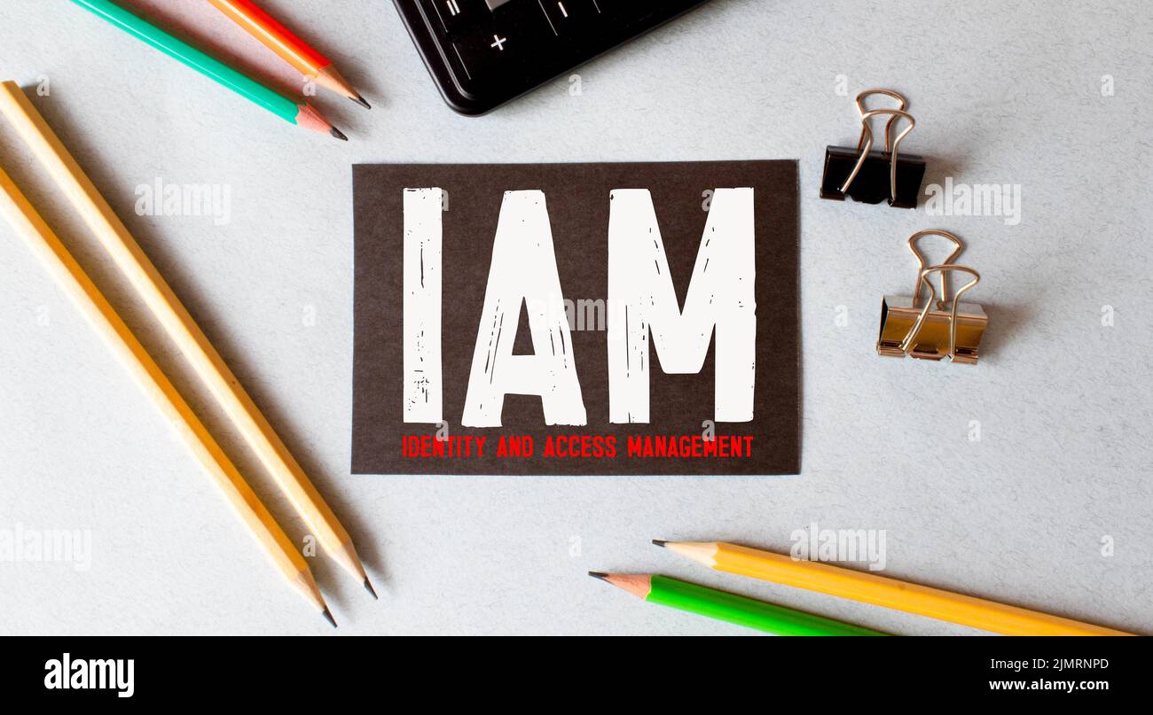 Closeup on businessman holding a card with IAM IDENTITY AND ACCESS ...
