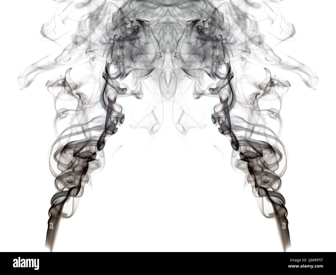 Puffs and curls of dark smoke on a white background rising from a ...