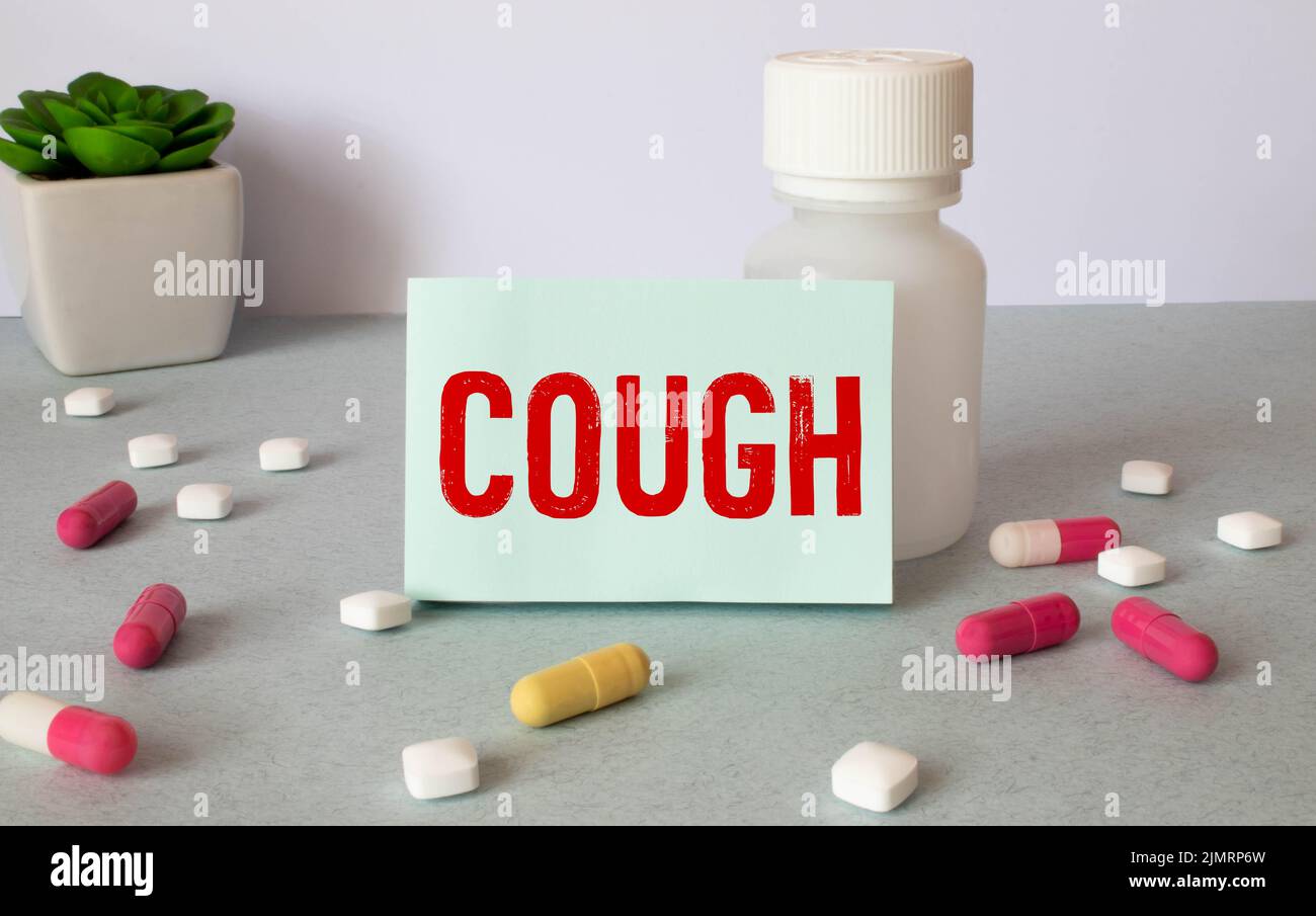 cough word written on a piece of paper on gray cork notice board ...