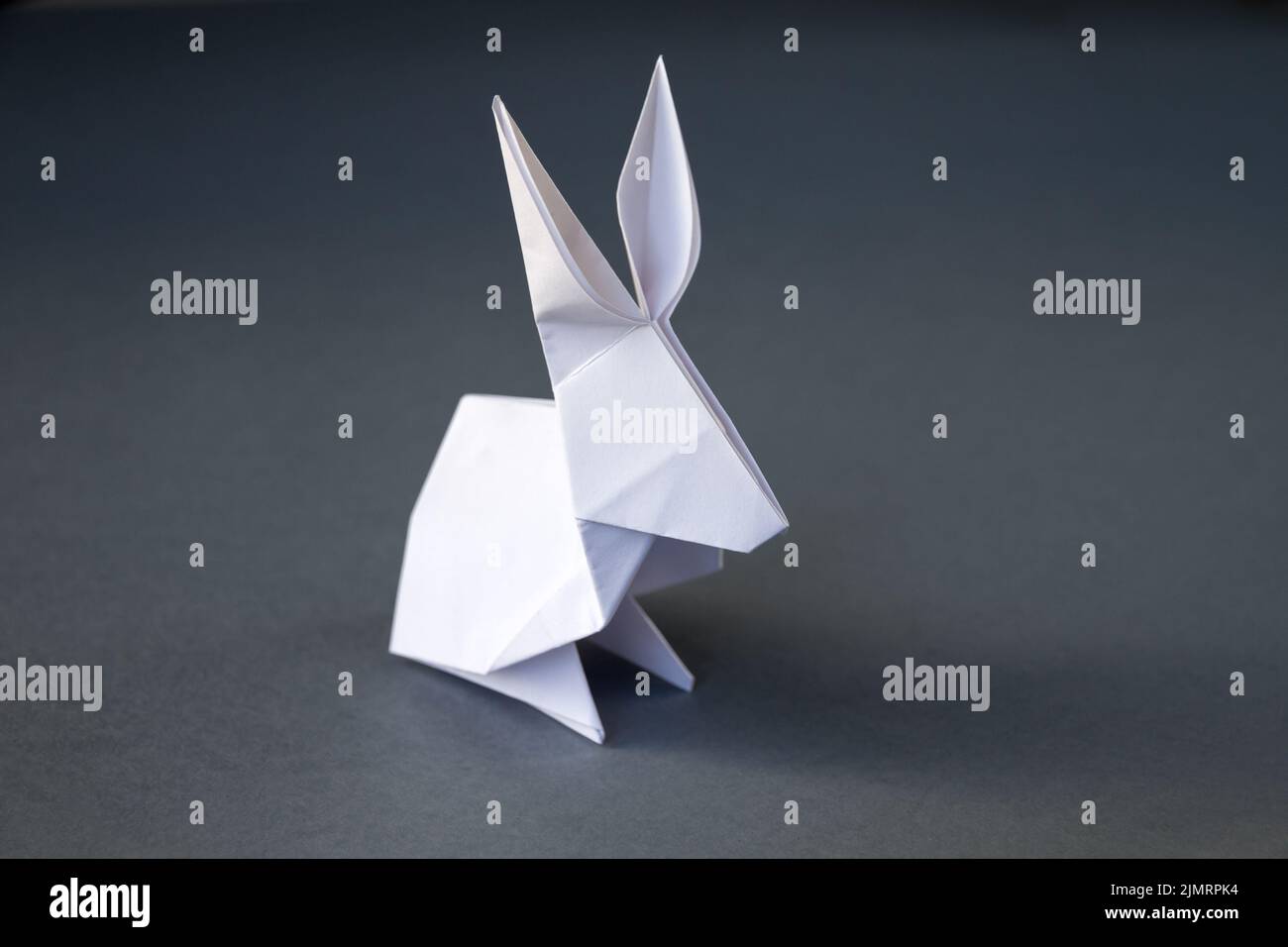 White paper rabbit origami isolated on a grey background Stock Photo ...