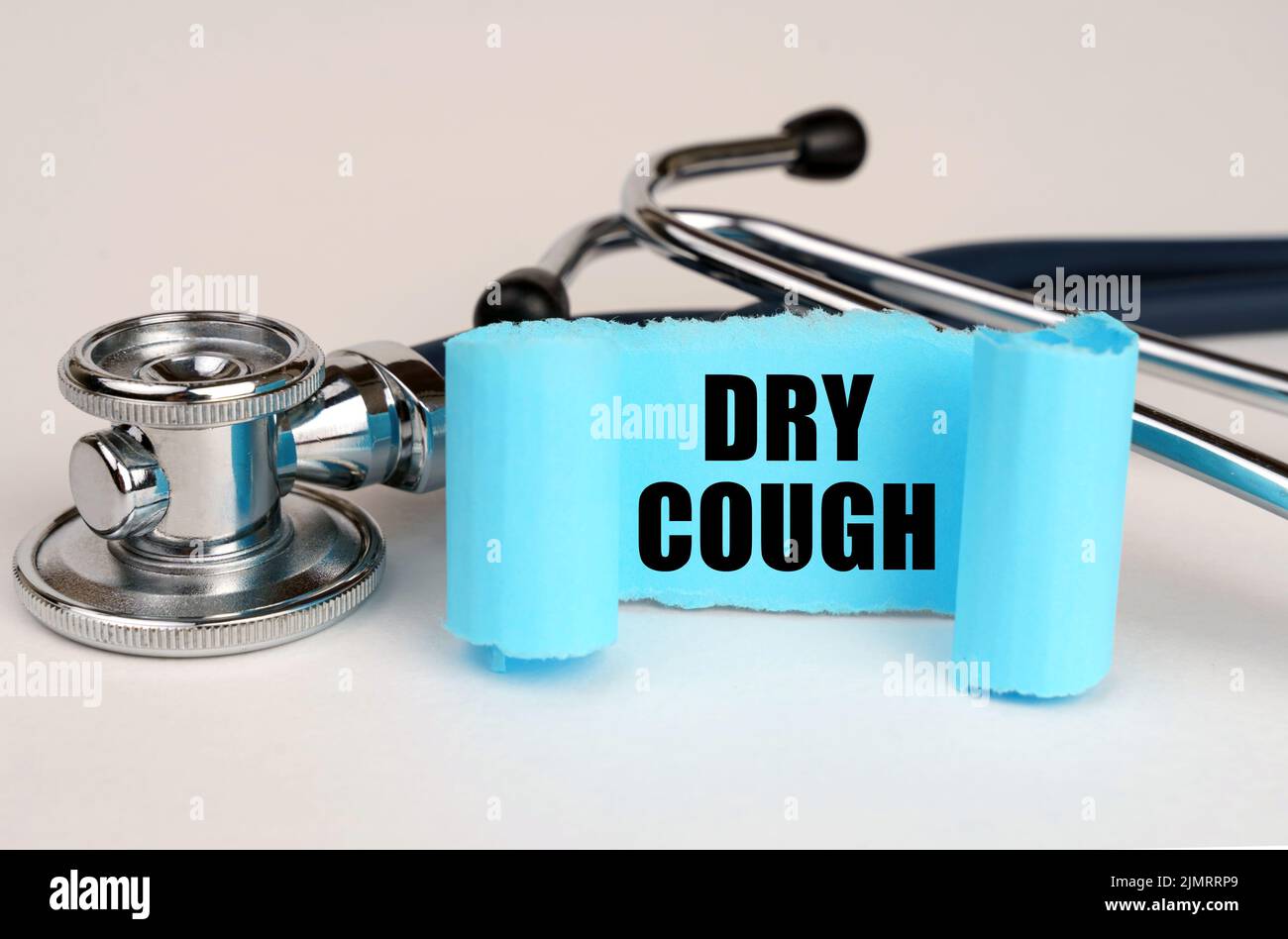 Medical concept. On a white surface lies a stethoscope and a blue roll ...