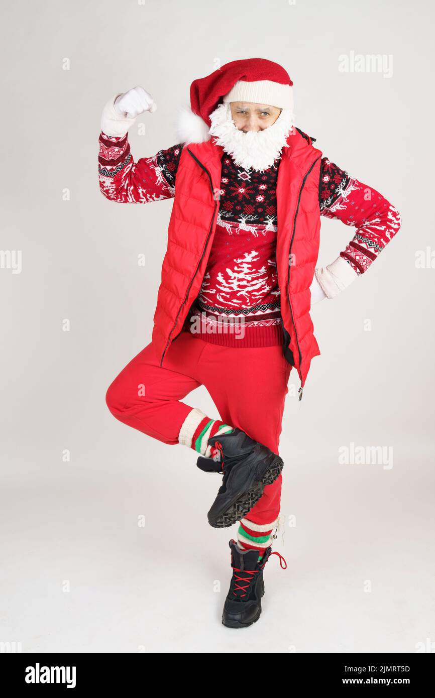 Christmas holidays concept. Cheerful Santa Claus demonstrates his ...