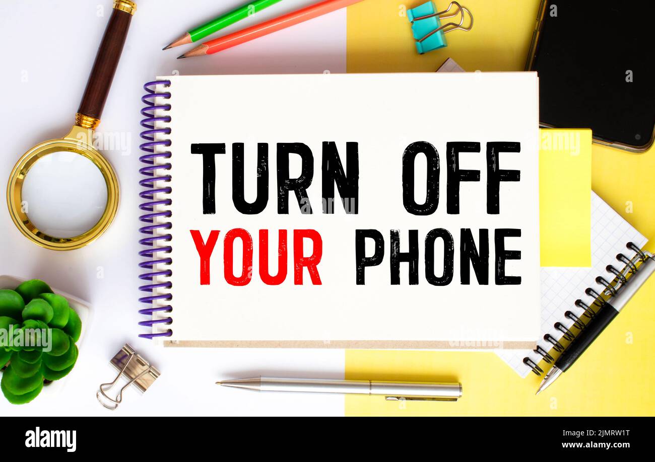 Business man pointing the text Turn Off Your Phone Stock Photo - Alamy