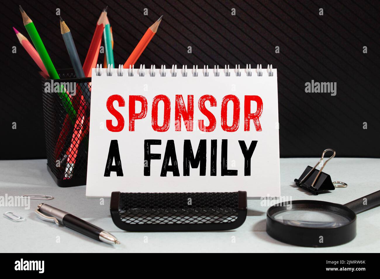 Sponsor A Family text written on a notebook with pencils Stock Photo ...