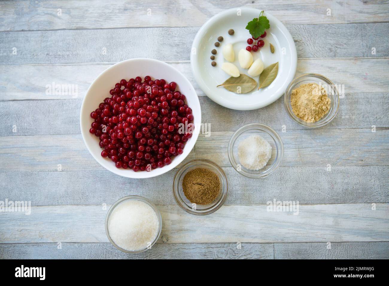 The process of making redcurrant sauce. Currant berries and spices are ...