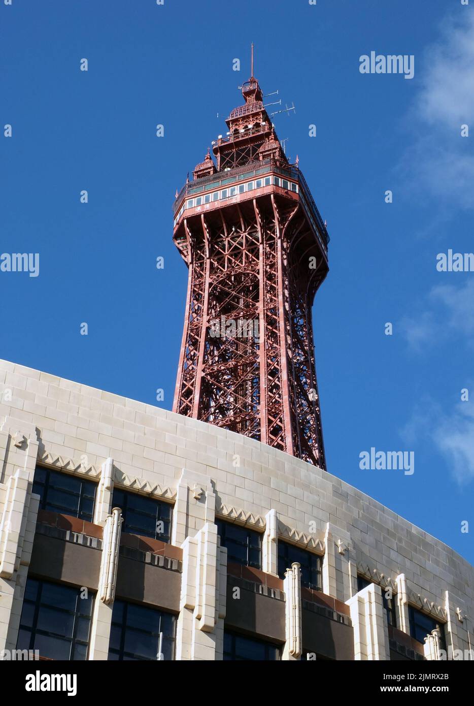 The historic 19th century blackpool tower against a sunlit blue cloudy ...