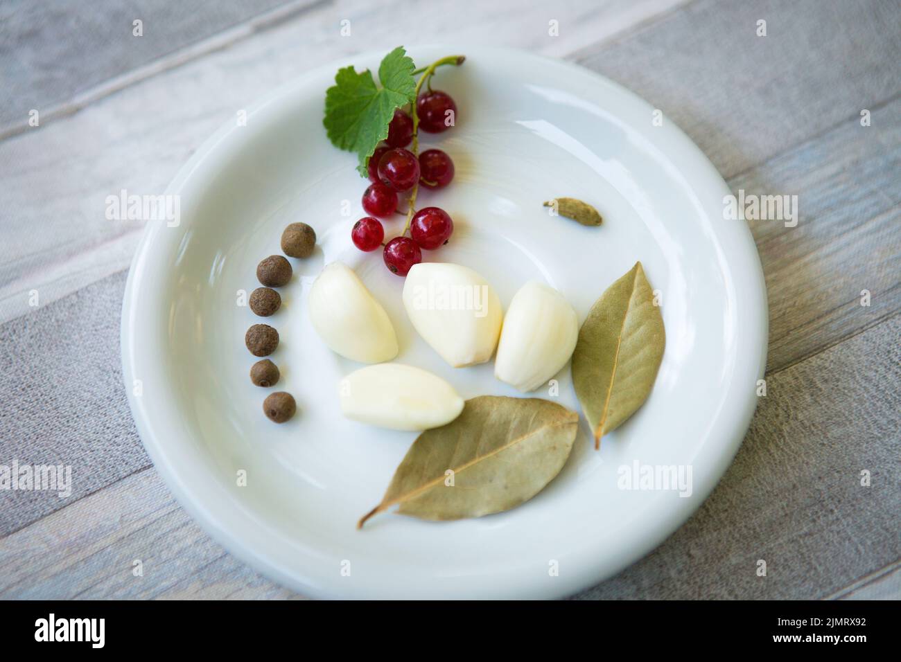 The process of making redcurrant sauce. Currant berries and spices are ...