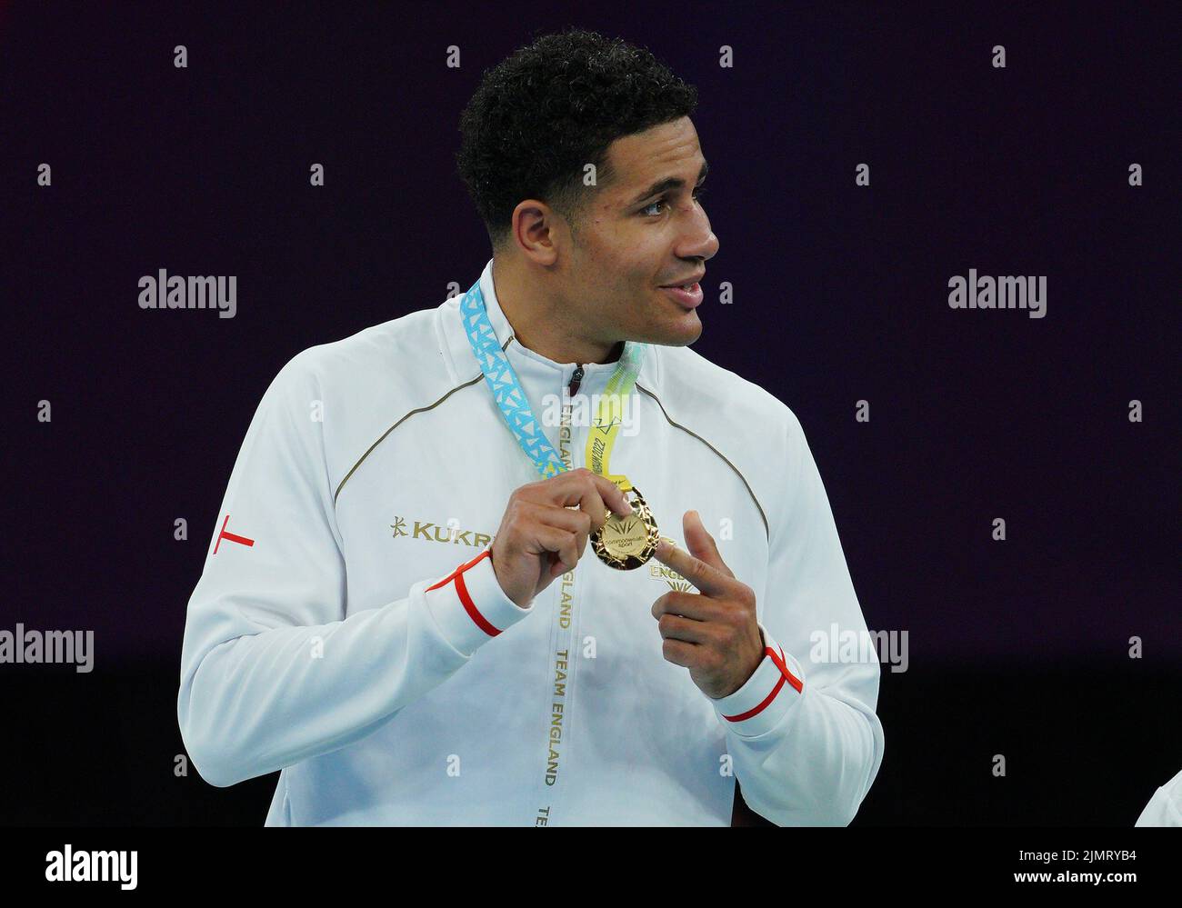 England's Delicious Orie celebrates with his gold medal after winning ...
