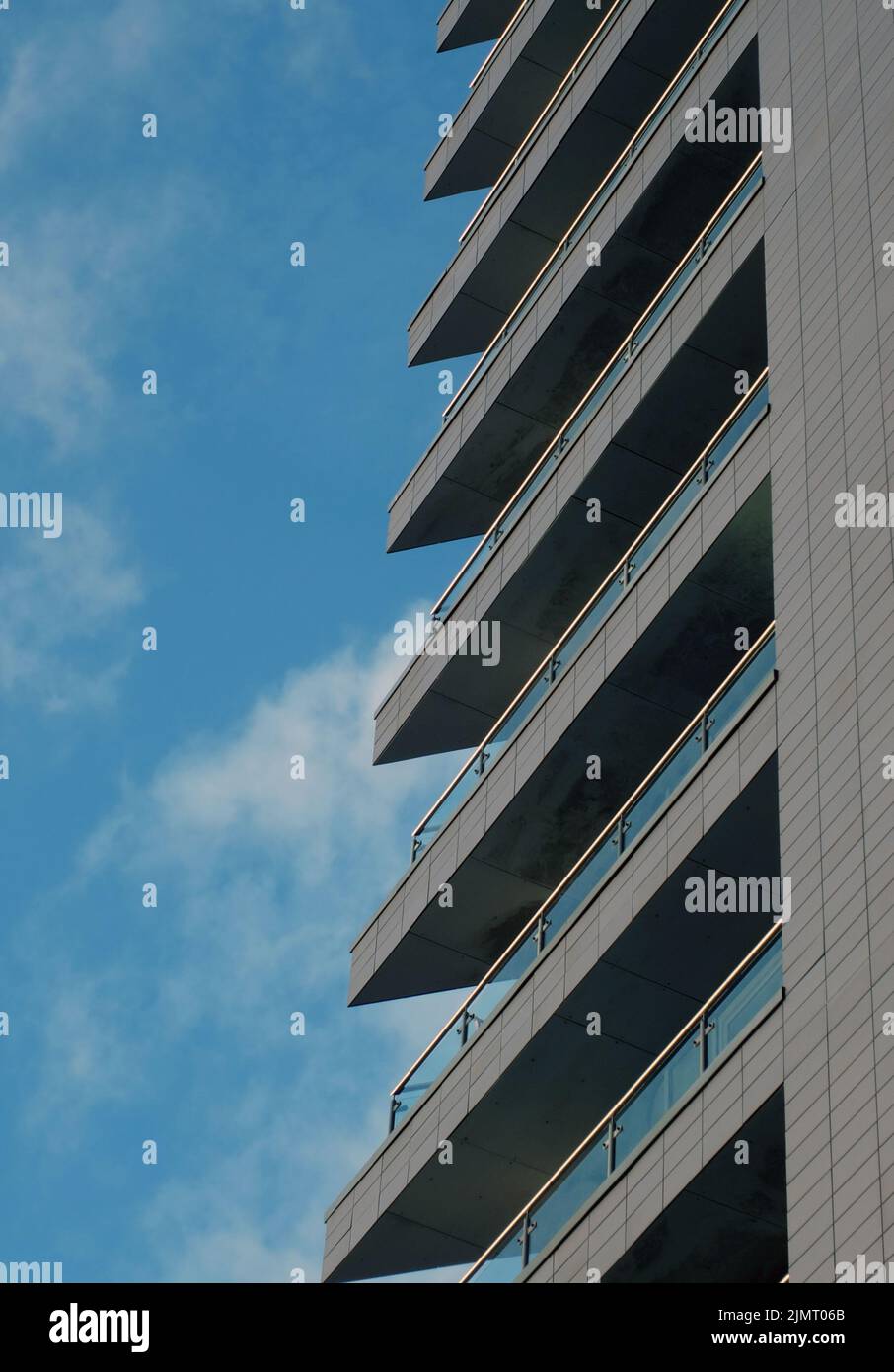 Angled balconies with glass covered railings on a modern apartment ...