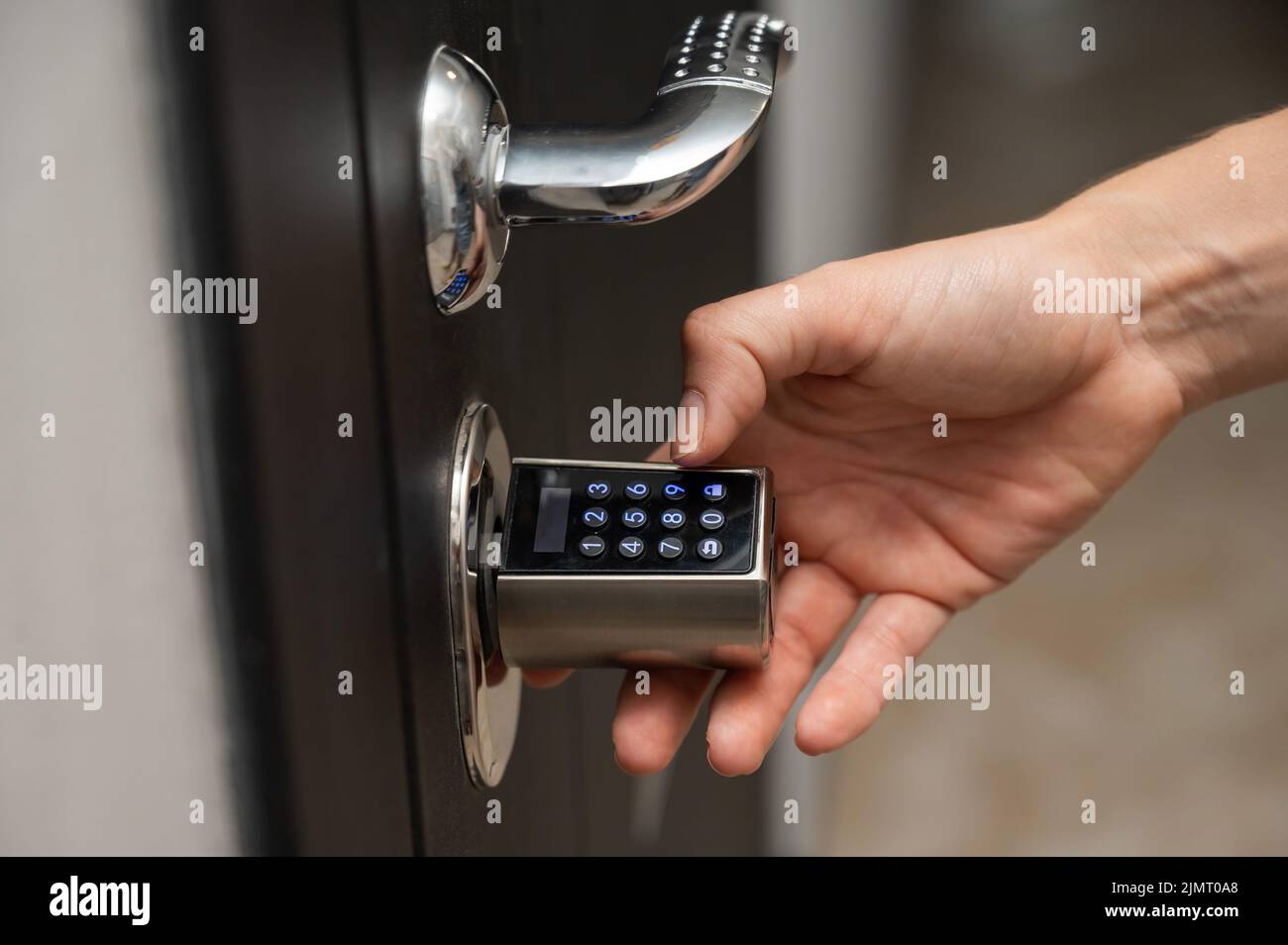 Woman opens the combination lock on the door to the apartment. Keyless ...