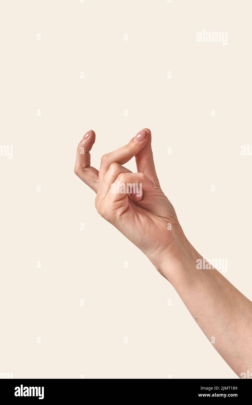 Finger snap woman hand with wrist on cream background Stock Photo - Alamy