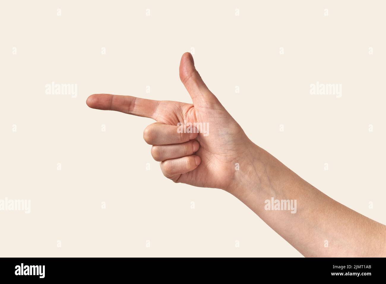 Female hand showing direction finger, arm on cream background Stock ...