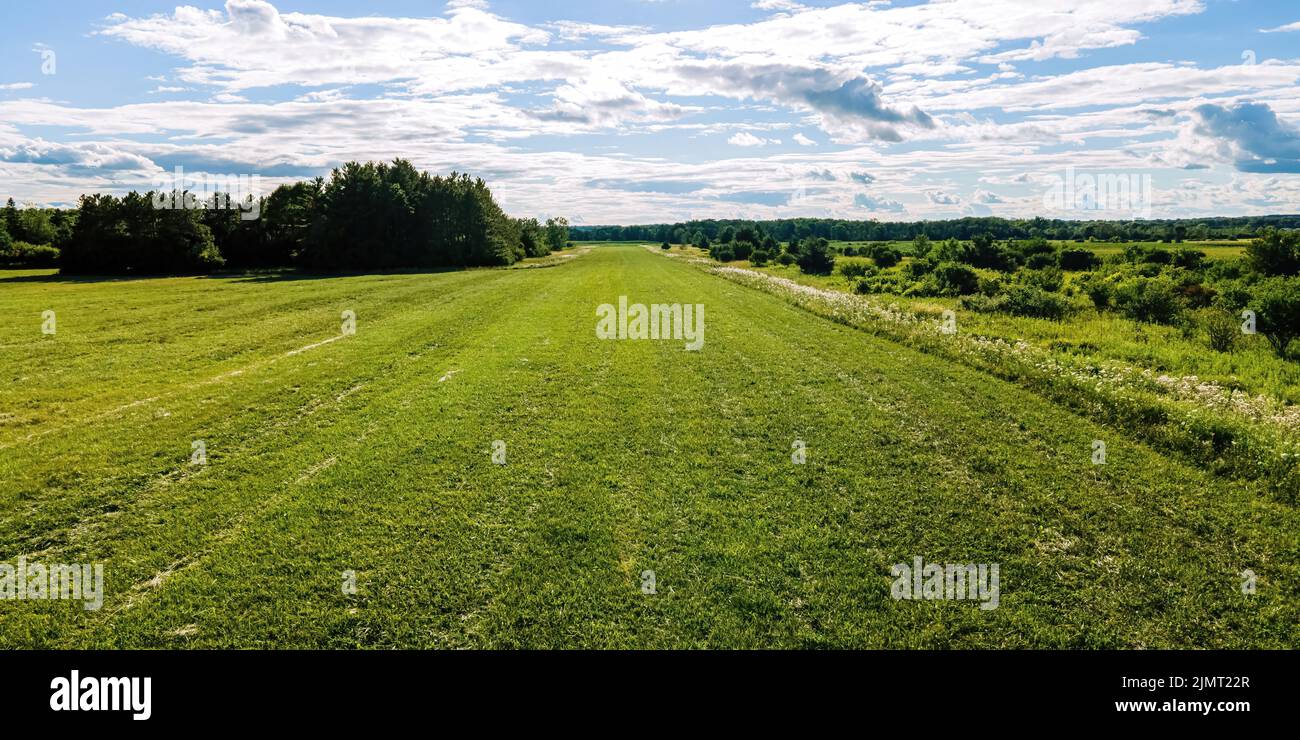 An empty freshly cut field in rural wisconsin where bales of hay were ...