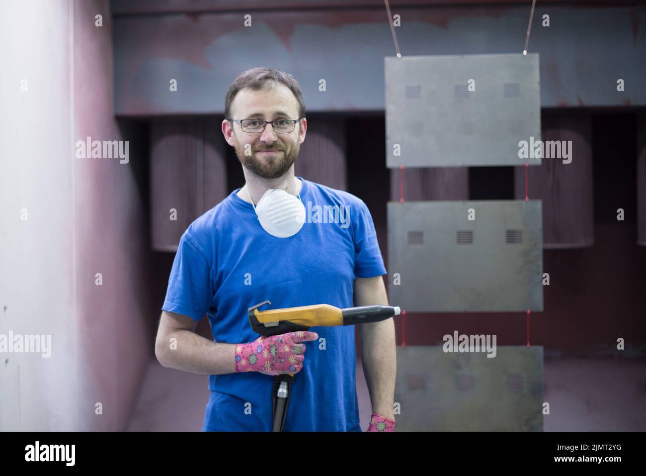 The painter paints the iron element. Industrial painting parts. Metal ...