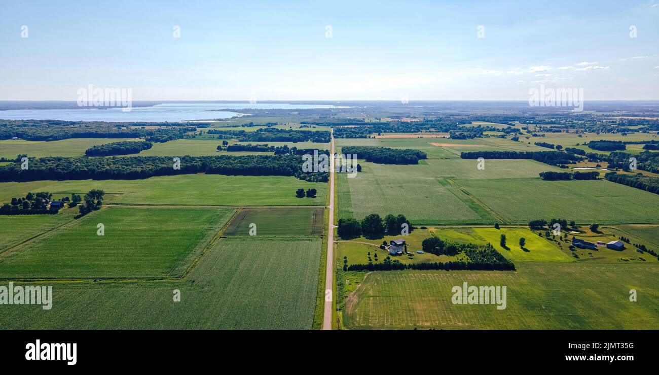 A rural scene of wisconsin farms during summer with lake winneconnie in ...