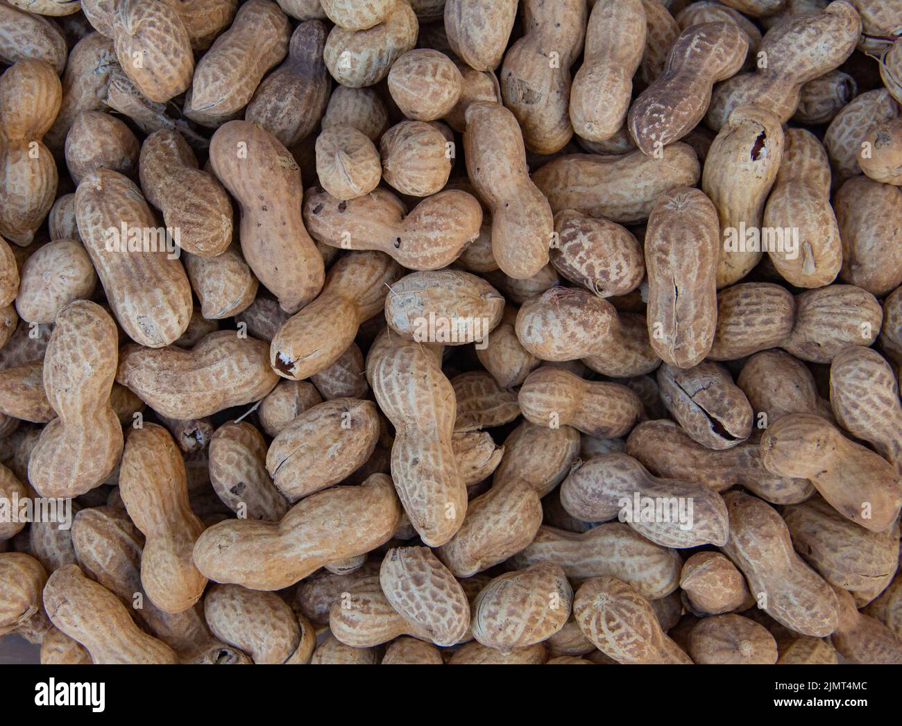 Bulk peanut texture background Stock Photo - Alamy