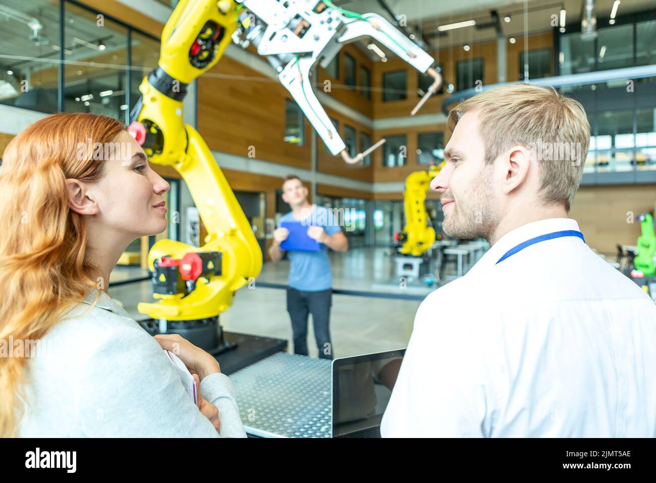 Engineers inspect industrial robot Stock Photo - Alamy