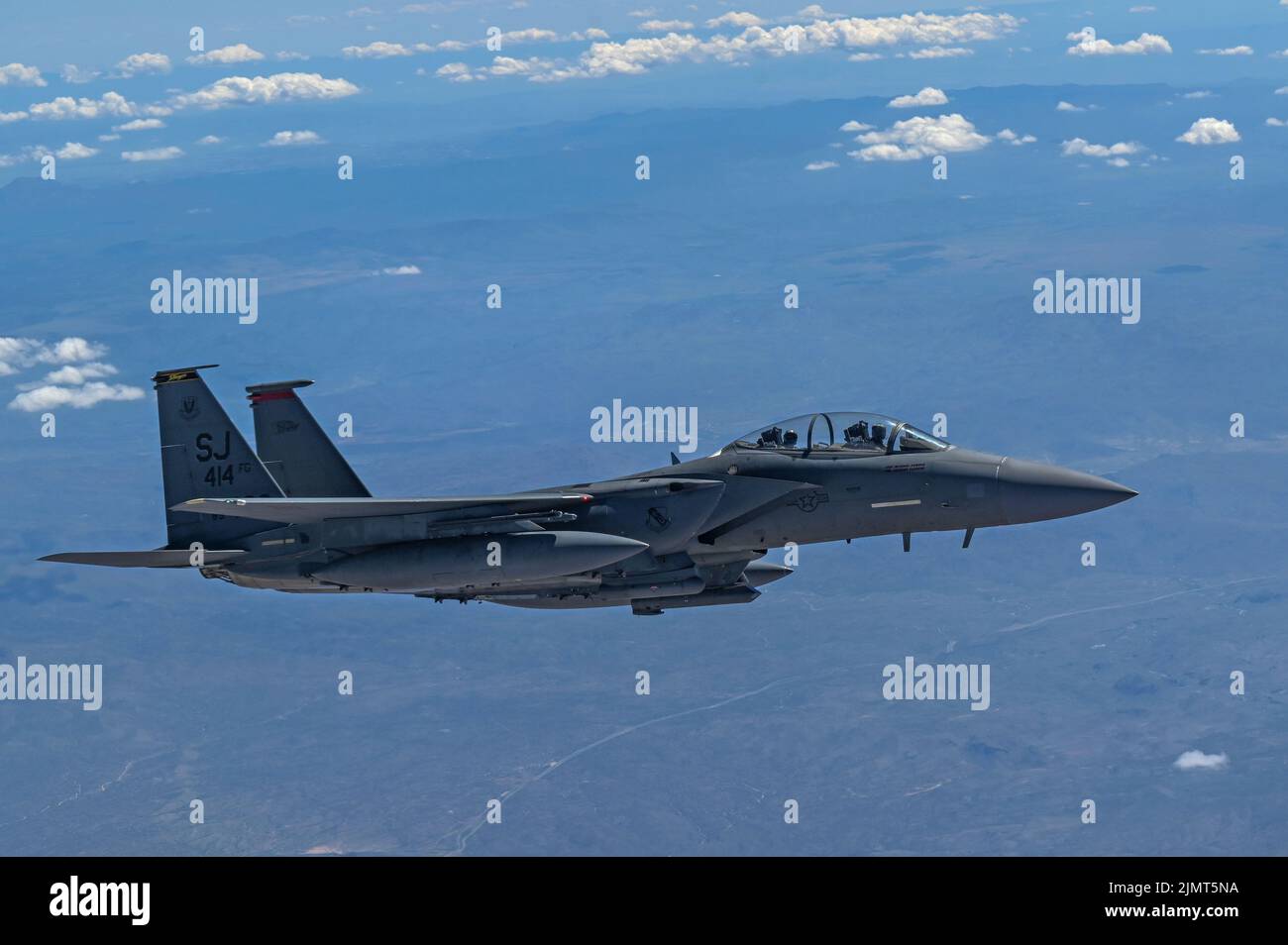 A U.S. Air Force F-15E Strike Eagle from the 414th Fighter Group flies in alongside a KC-135 ...