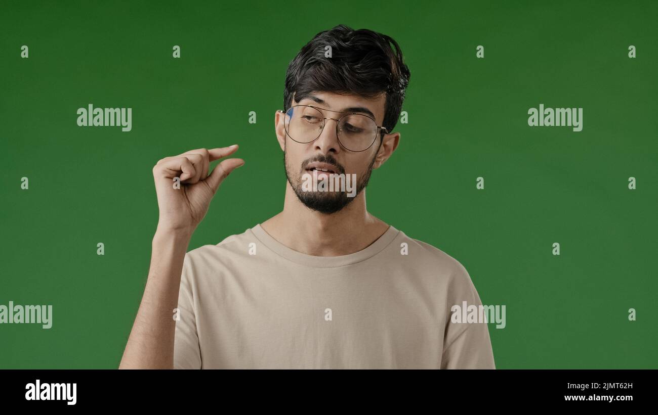 Disappointed unhappy brunette arabian man make little bit gesture with ...