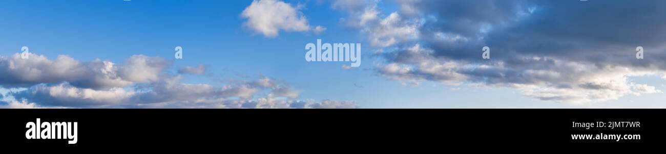 Blue sky with clouds in sunshine (wide natural cloudscape background panorama Stock Photo - Alamy