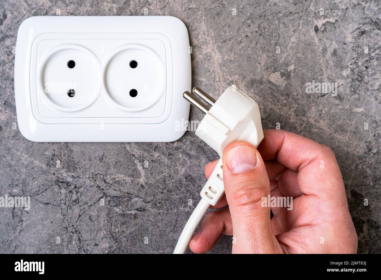 Male hand puts plug hi-res stock photography and images - Alamy