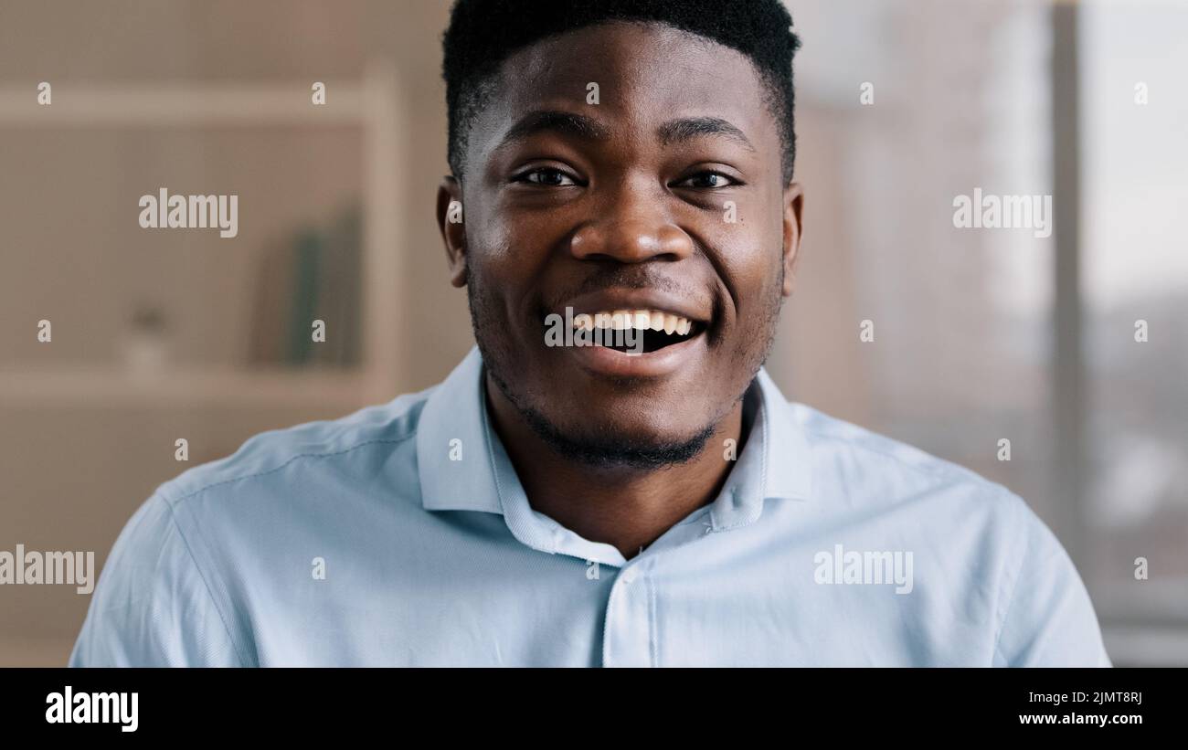 Pleasantly surprised african american man wears blue shirt makes big ...