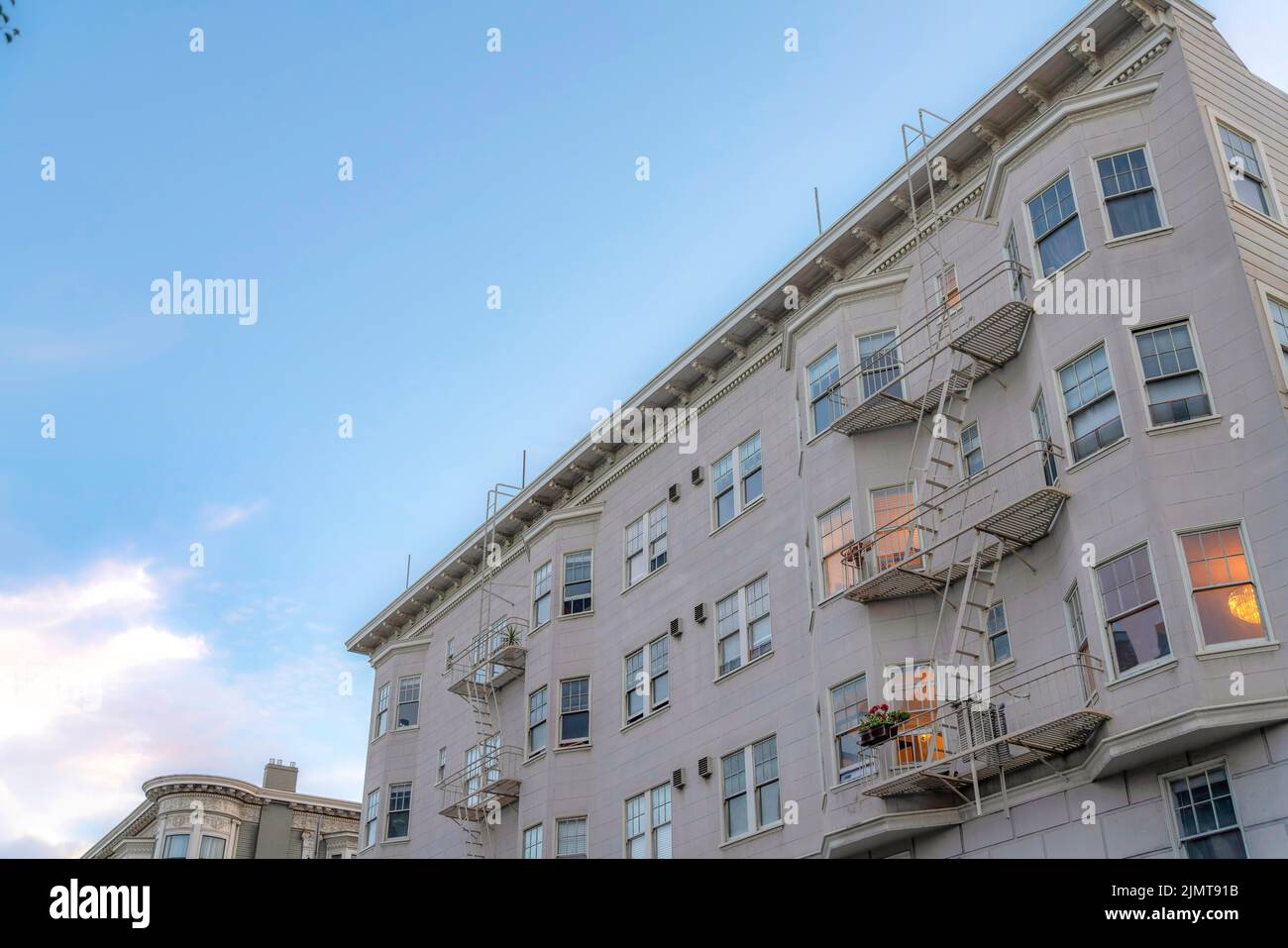 Apartment building with beige exterior and emergency stairs exit in a ...