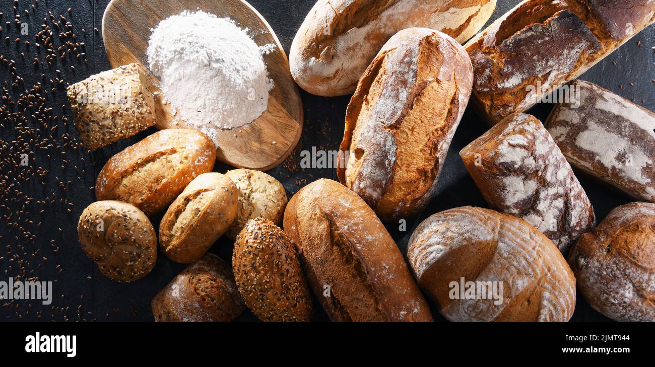 Assorted bakery products including loafs of bread and rolls Stock Photo ...