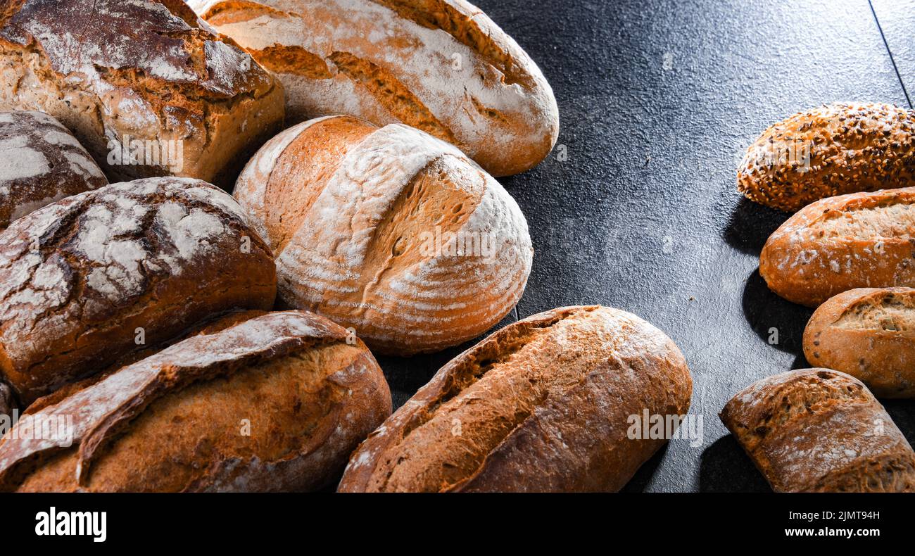 Assorted bakery products including loafs of bread and rolls Stock Photo ...
