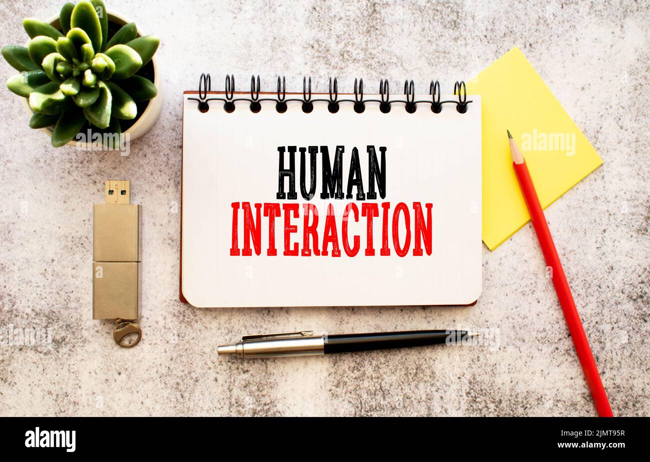 text HUMAN INTERACTION on white paper Stock Photo - Alamy