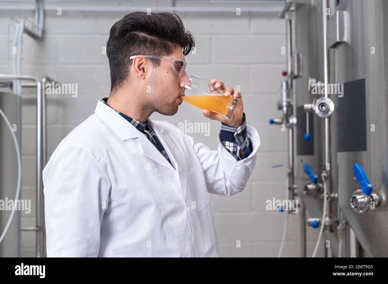 Brewer testing beer at brewery factory Stock Photo - Alamy