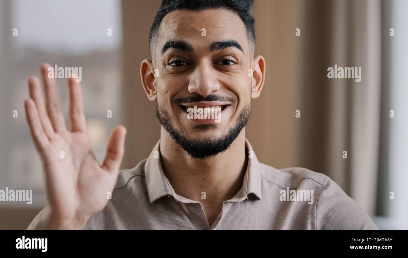 Hispanic handsome business man millennial wave hand greet look at ...