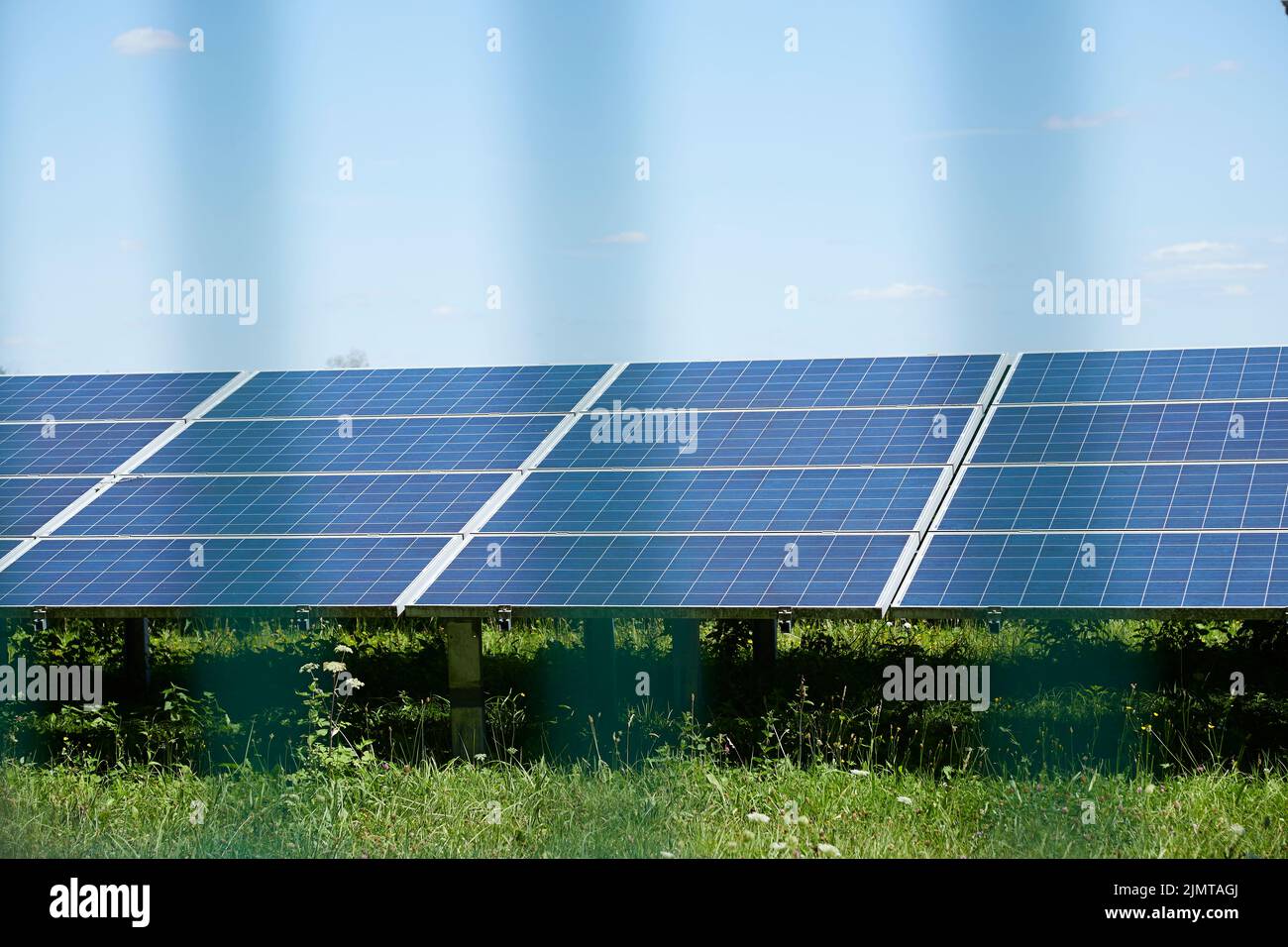 solar panel system behind a fence, renewable energy Stock Photo - Alamy