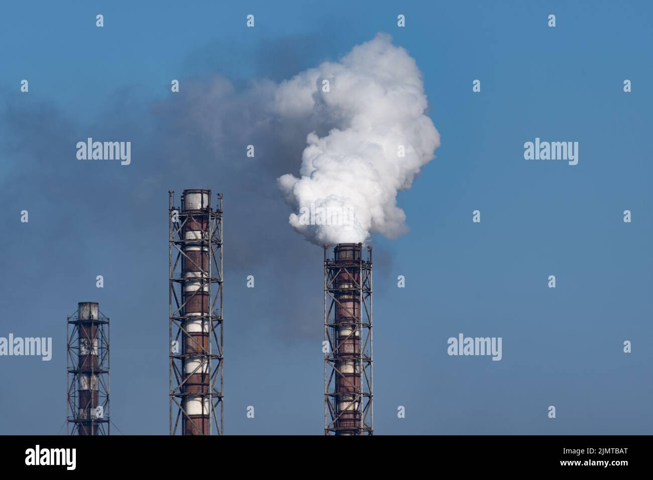Smoke stack of coal power plant on blue sky background Stock Photo - Alamy