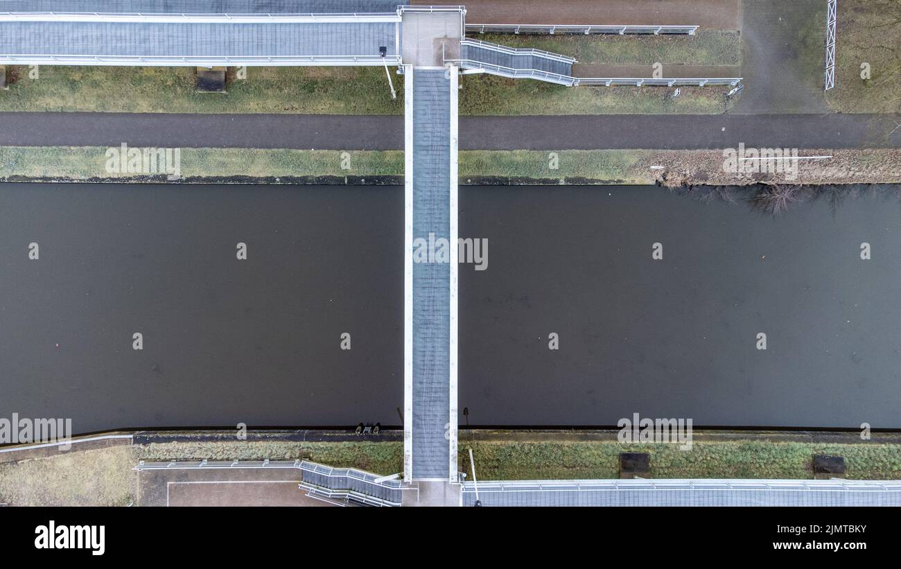 Aerial view of a walking or pedestrian bridge over a canal or river ...
