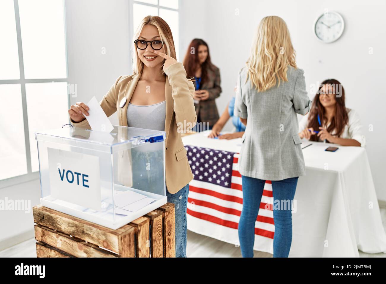 Group of young girls voting at democracy referendum pointing with hand ...