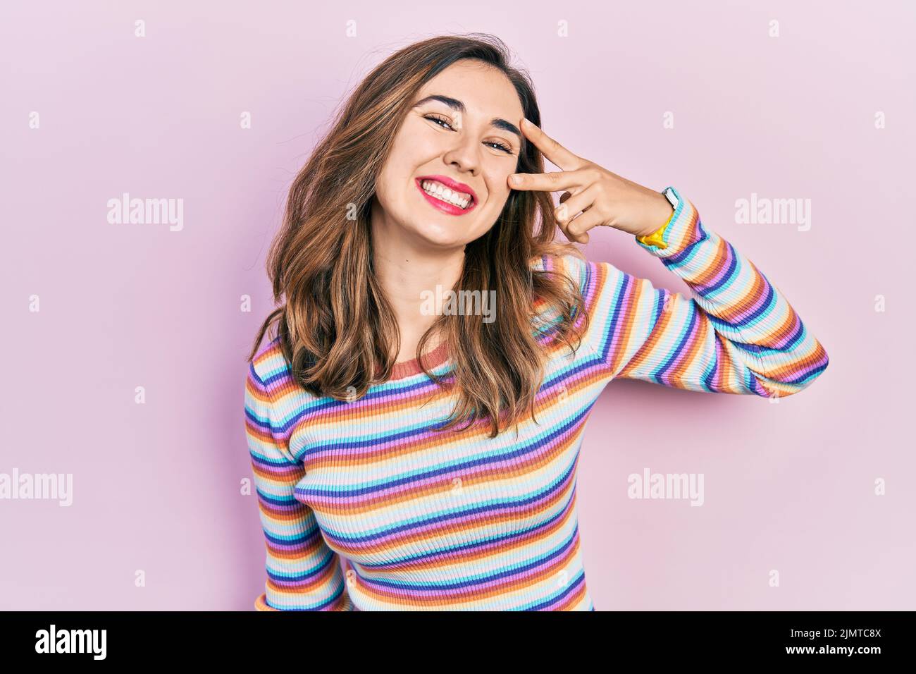 Young hispanic girl wearing casual clothes doing peace symbol with ...