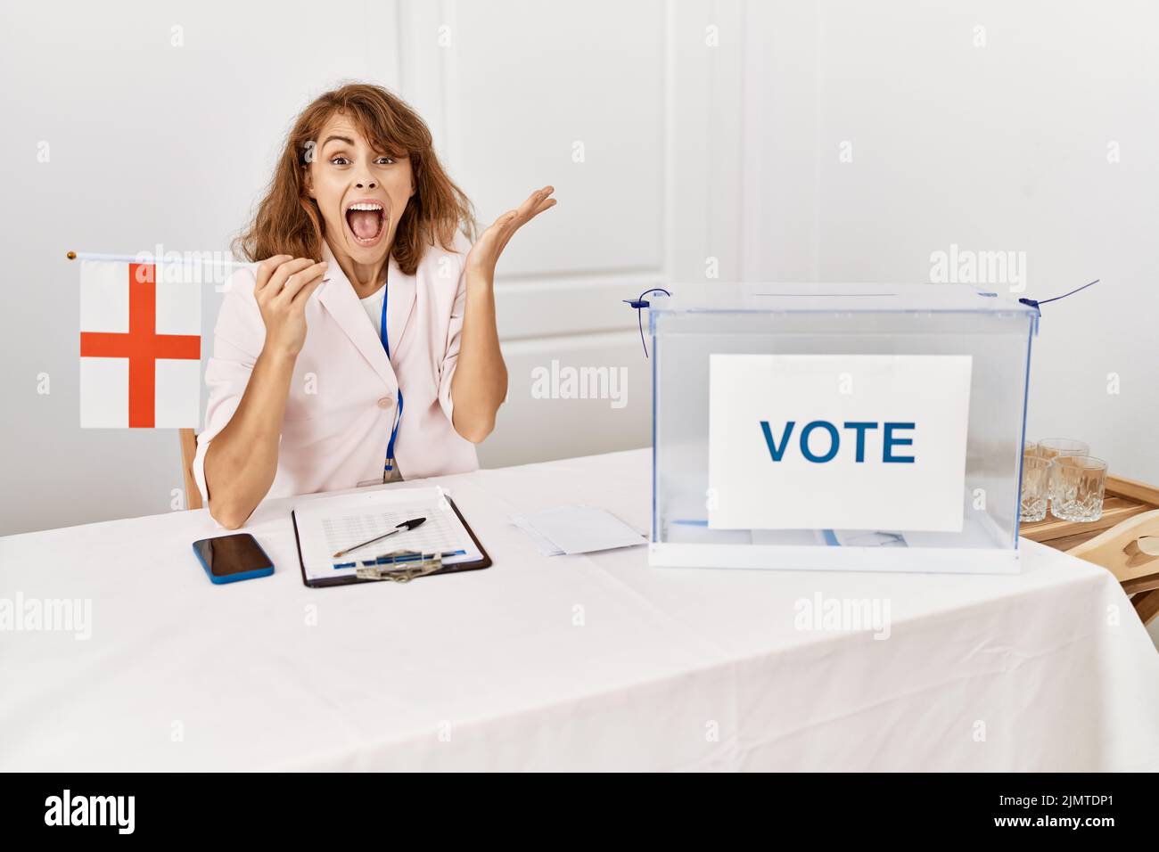 Beautiful caucasian woman at political campaign election holding ...